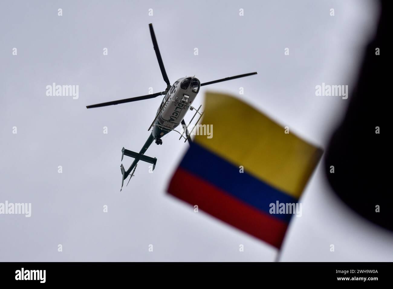A Colombian police helicopter flies during a demonstration demanding ...