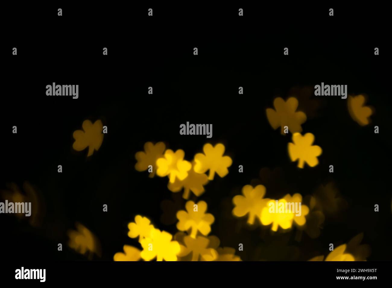 glare, bokeh, lights in the shape of clover leaves on a black ...