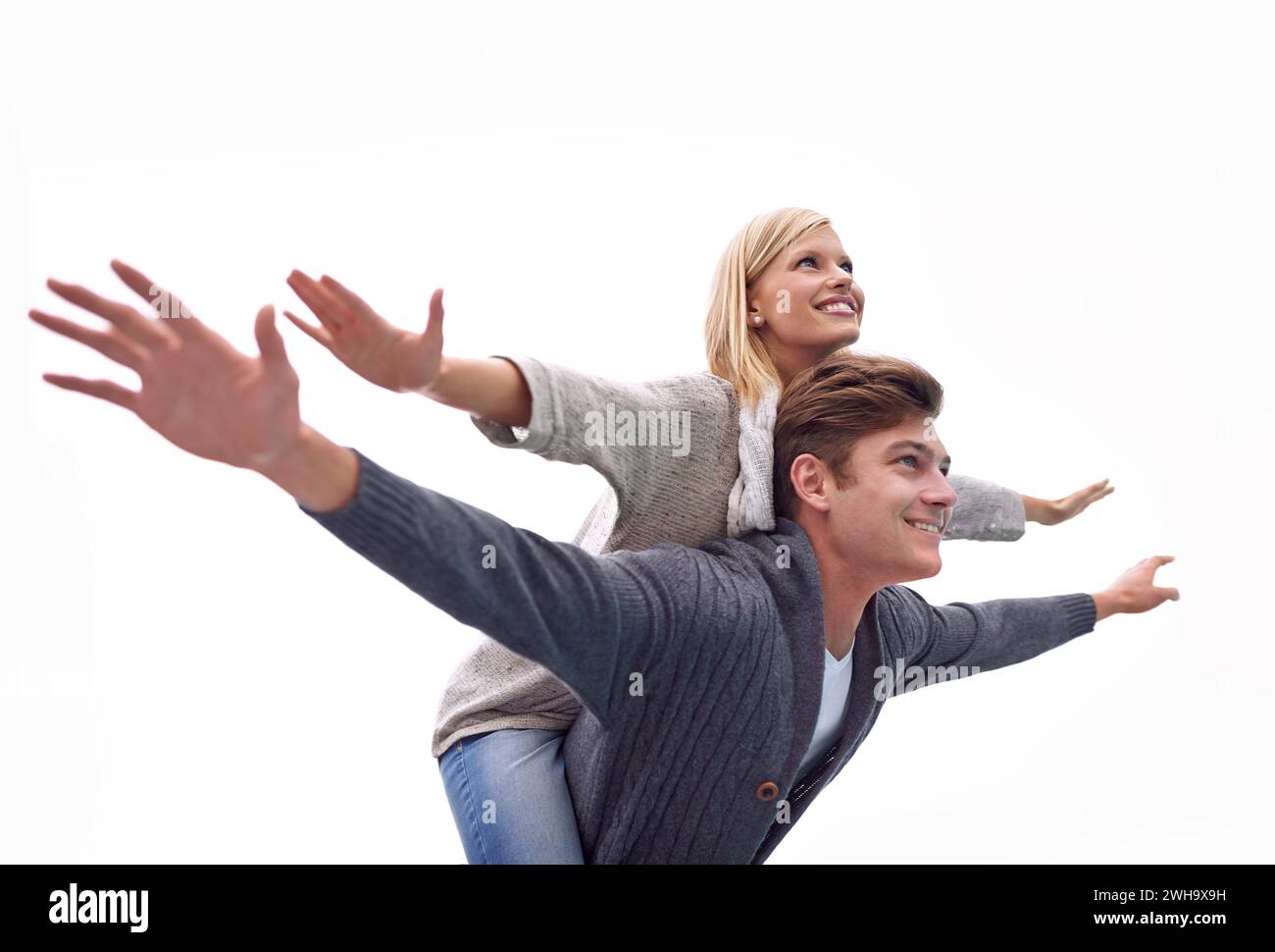 Couple, piggy back and airplane with arms, smile and funny game with ...