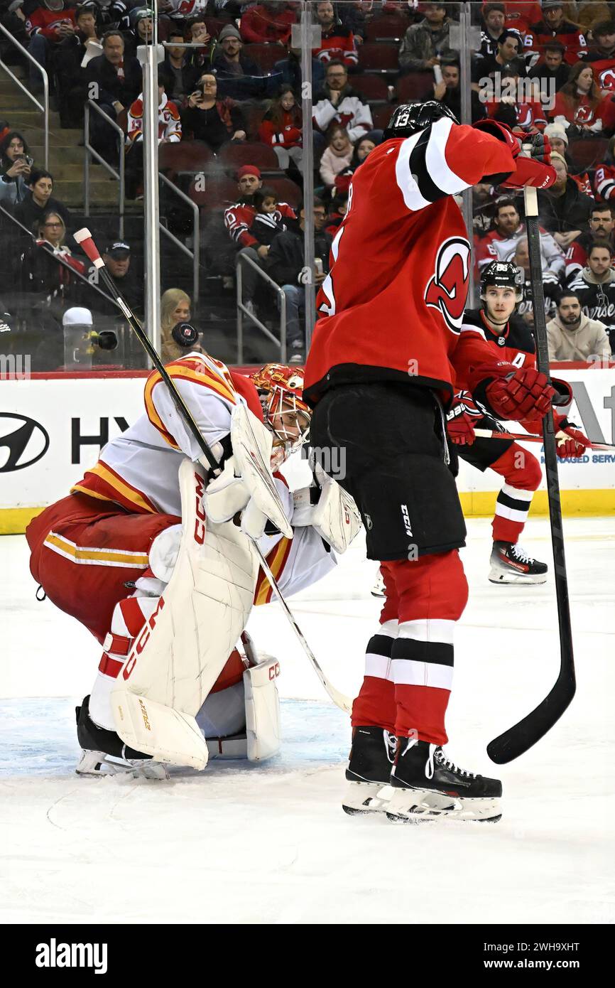 Calgary Flames goaltender Jacob Markstrom (25) deflects the puck as he is screened by New Jersey ...
