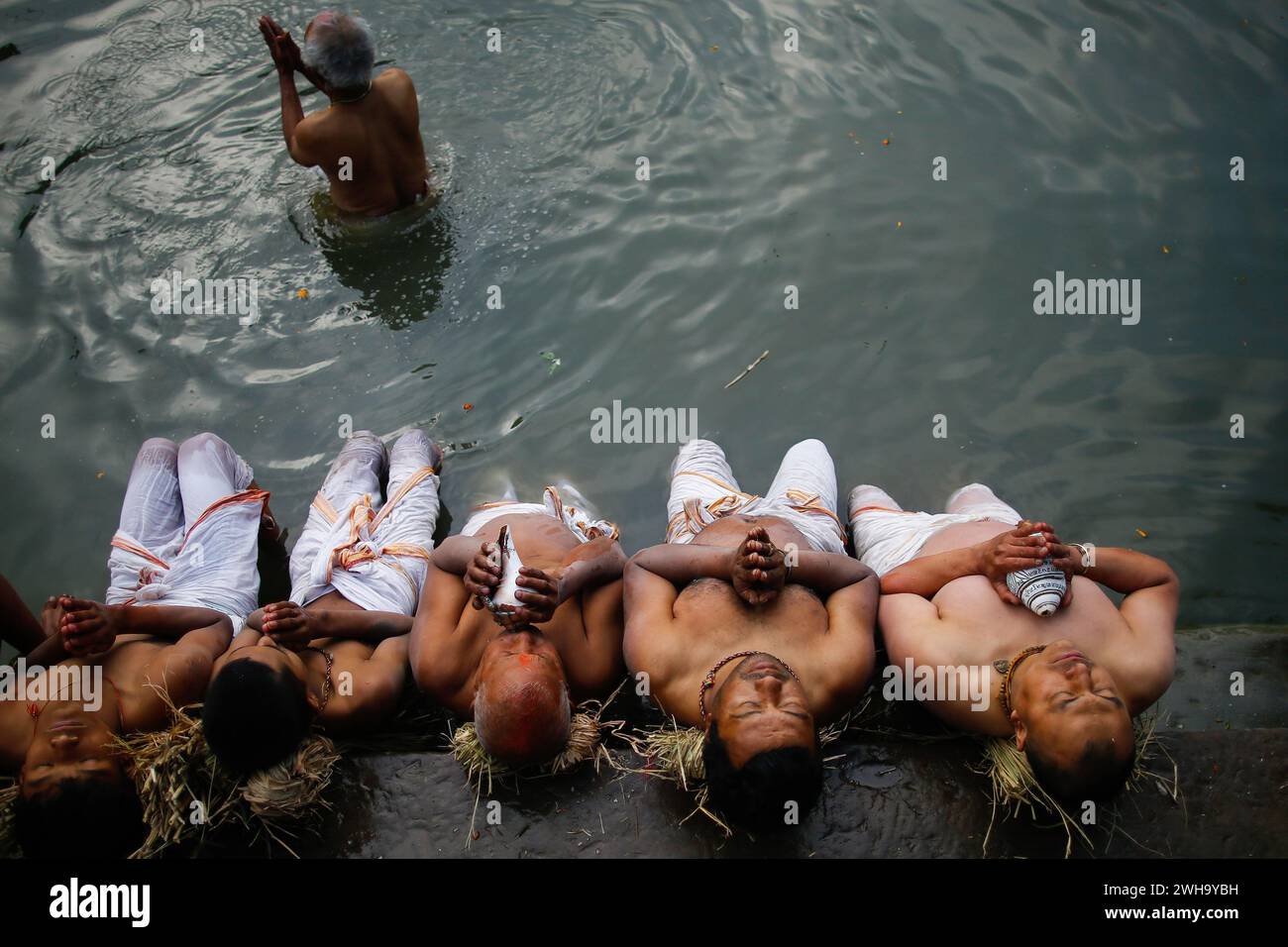 Bhaktapur, Nepal. 09th Feb, 2024. Devotees submerge themselves in the ...