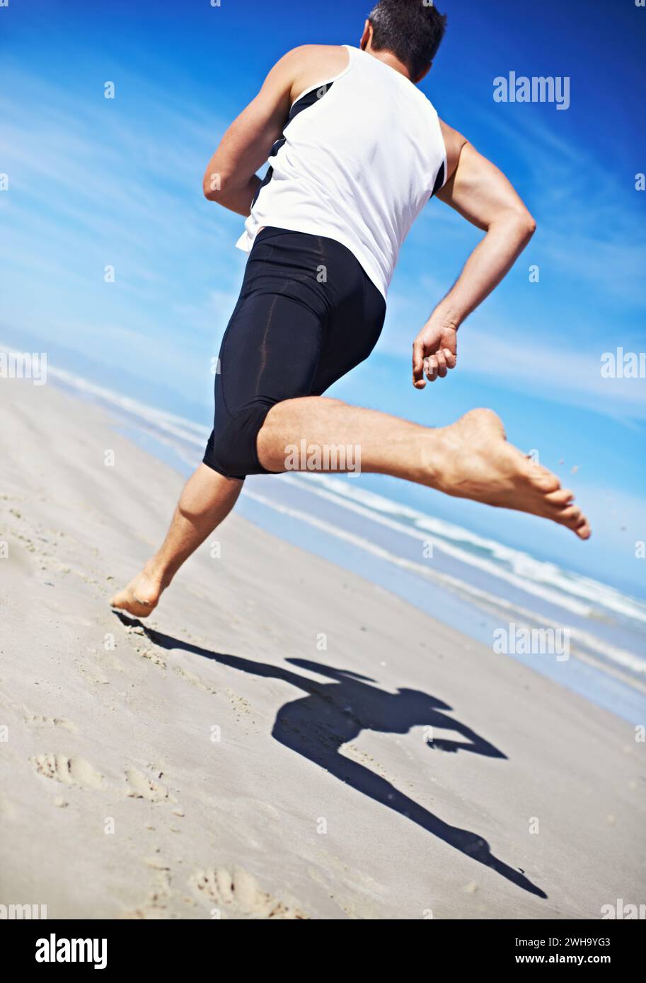Man, running and water at beach with fitness, sport and training for ...