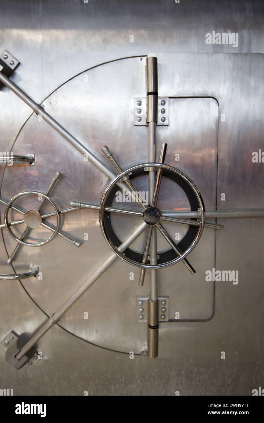 Close up of a shining Bank safe. Door with wheels and locks Stock Photo ...