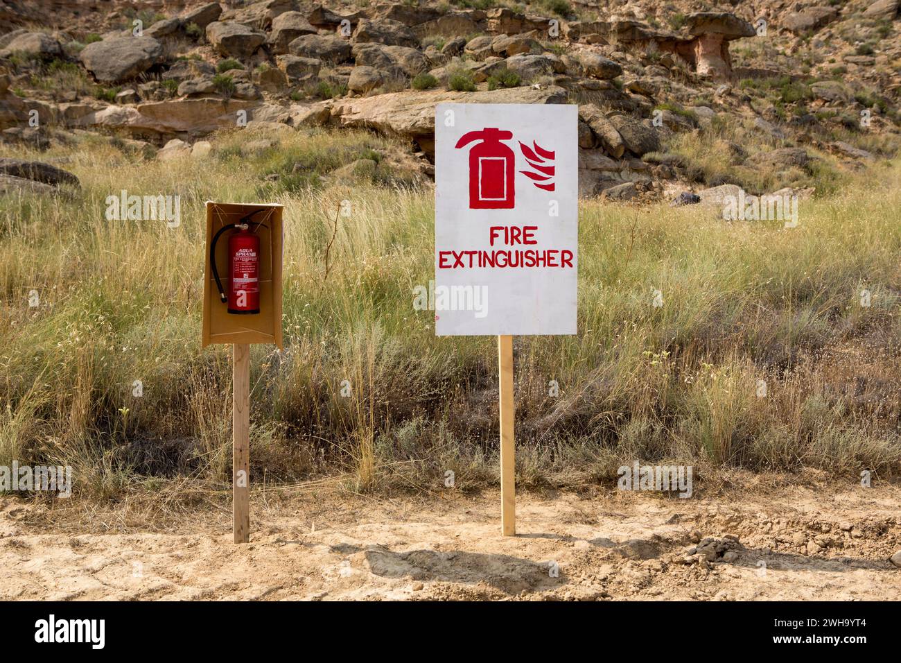 Red Fire sign and fire extinguisher with nature in the background Stock ...