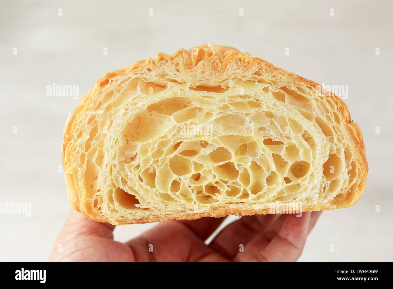 Close Up Croissant Texture, Baker hand Hold Half Croissant Show the ...
