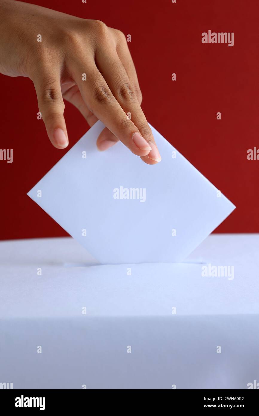 Female Voter Inserting Vote Card to Ballot Box with Red Background ...