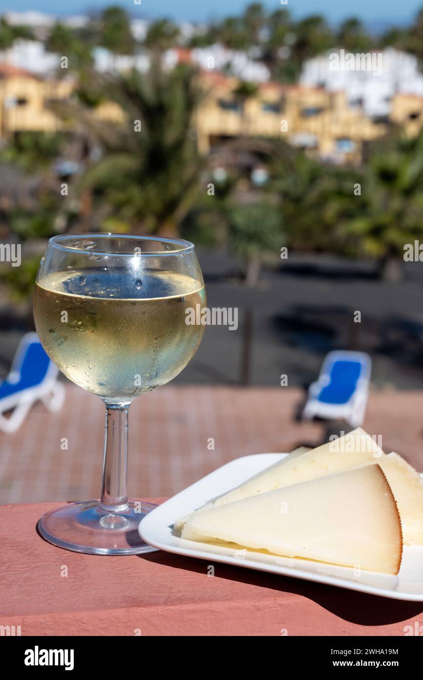 Spanish hard manchego, cow, sheep and goat cheese, glass of cold white ...