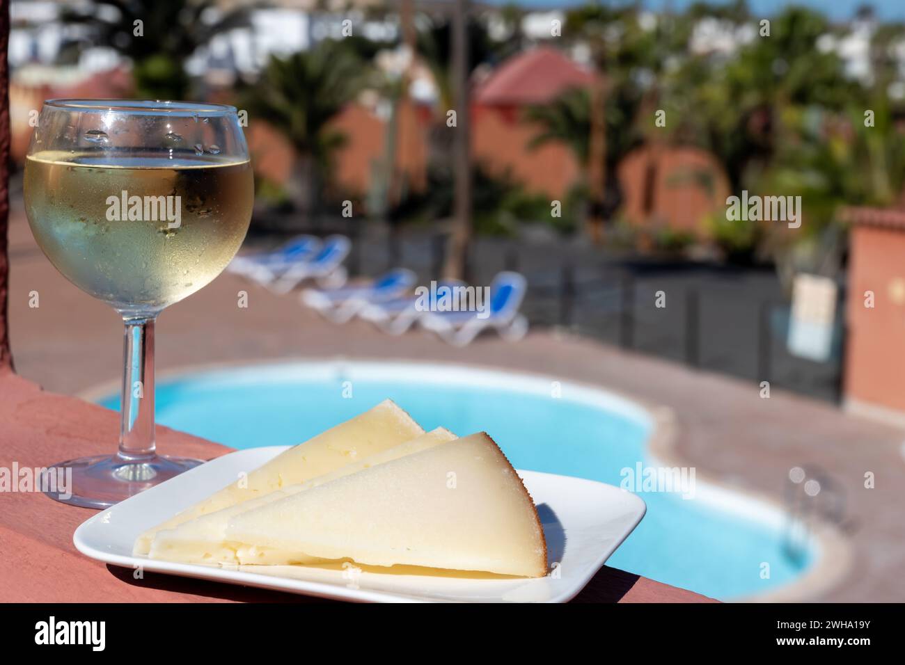 Spanish hard manchego, cow, sheep and goat cheese, glass of cold white ...