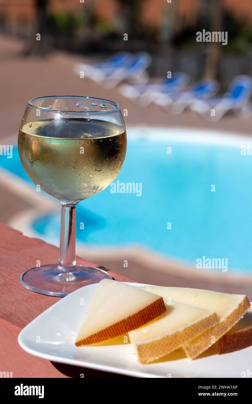 Spanish hard manchego, cow, sheep and goat cheese, glass of cold white ...