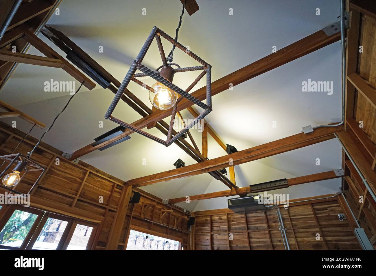 Hanging lighting lamp and interior design of wooden room in industrial ...