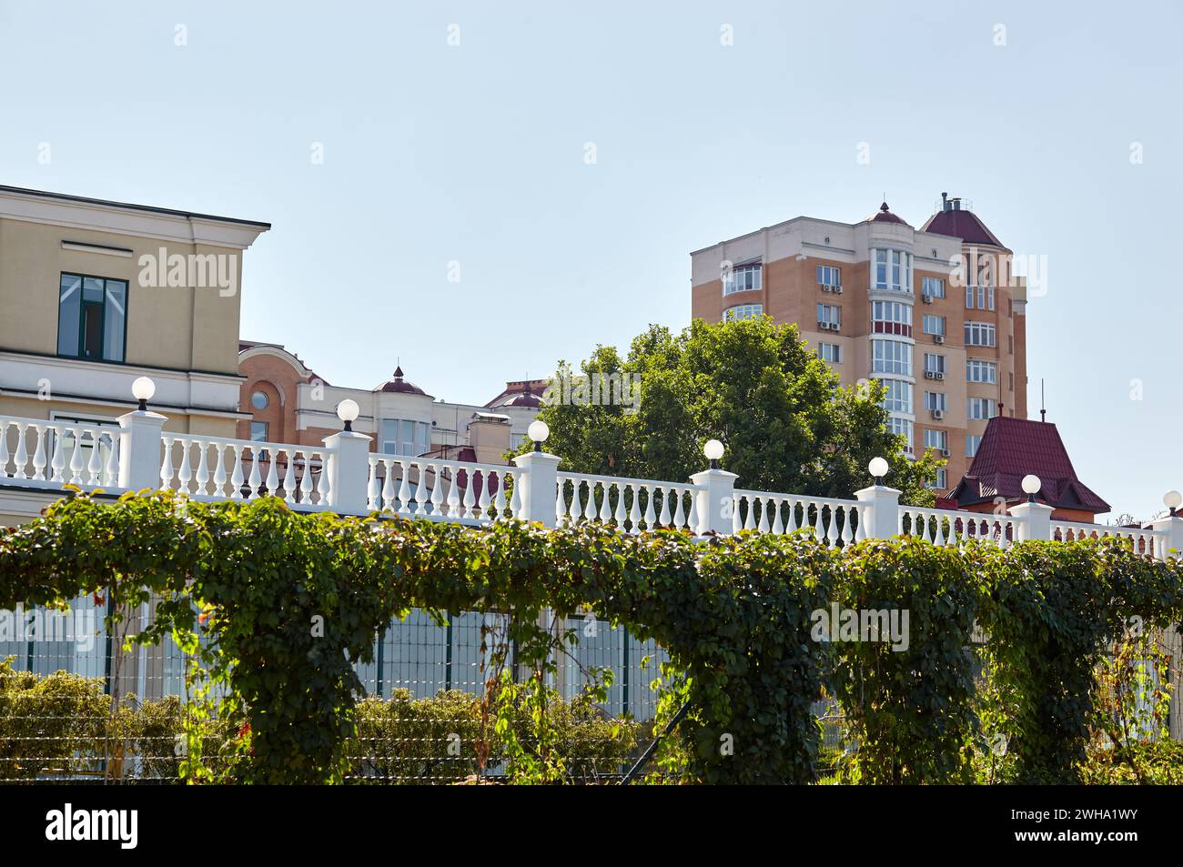 Fragment of the terrace with columns, lamps and railings. White stone ...