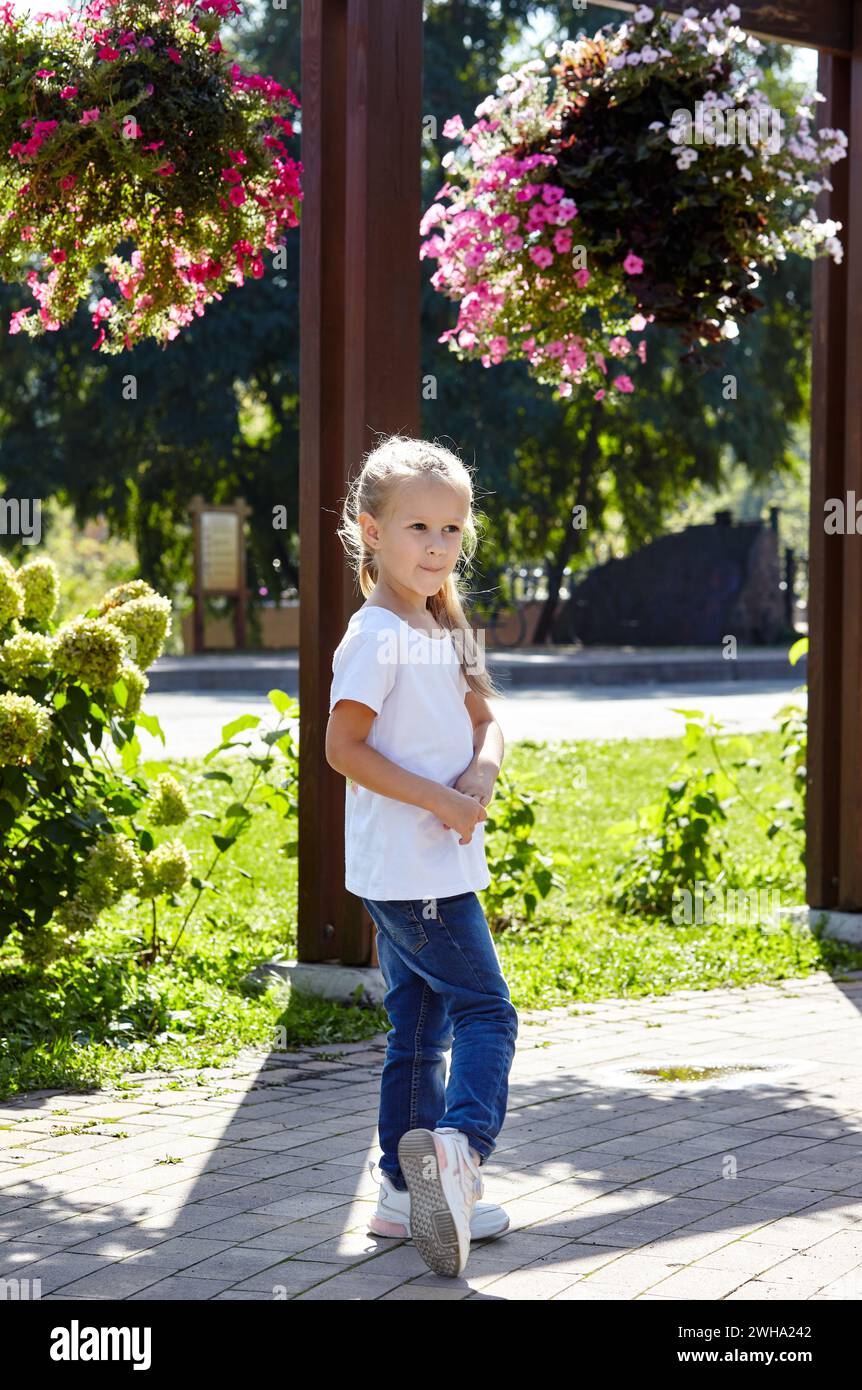 Little girl walk in the summer city park. Childhood, leisure and people ...