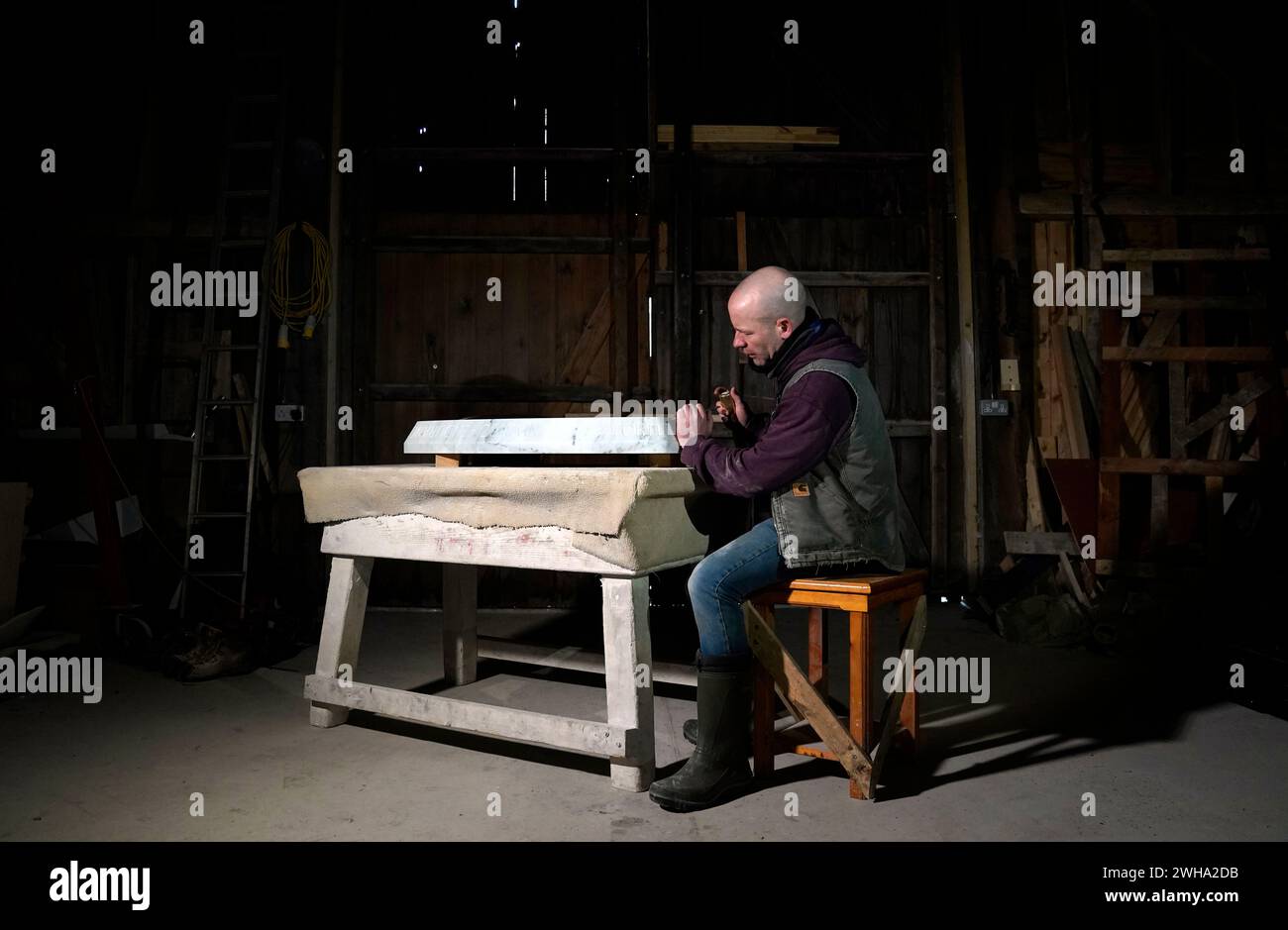 Stonemason Will Davies adds the finishing touches to a memorial stone ...