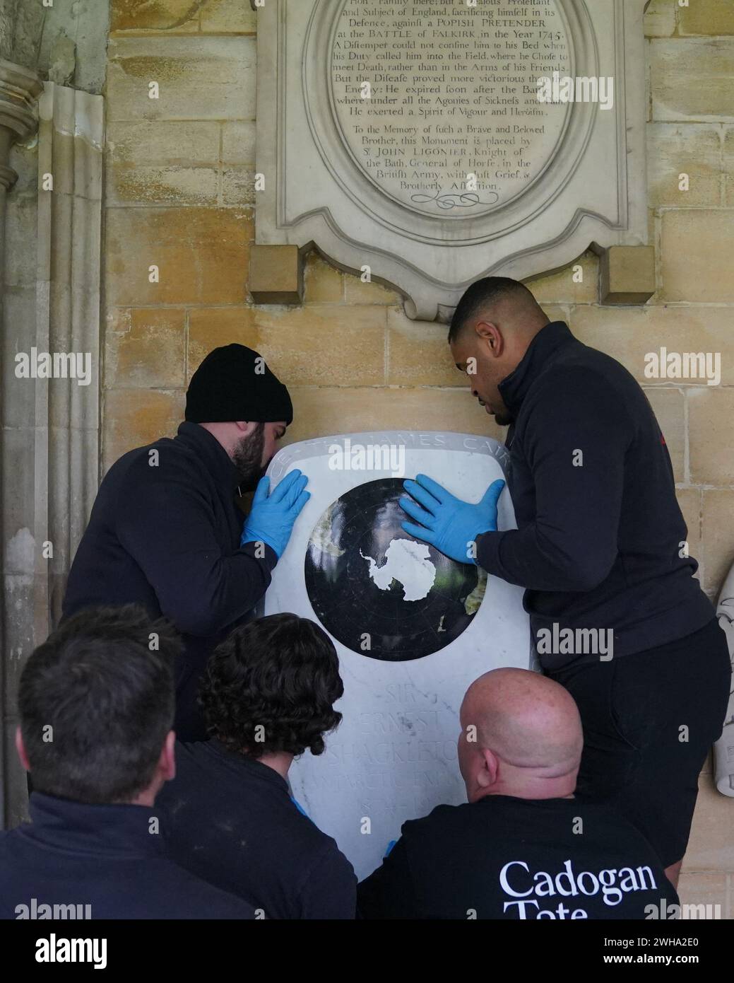 Workers put the memorial stone for Sir Ernest Shackleton into place in ...
