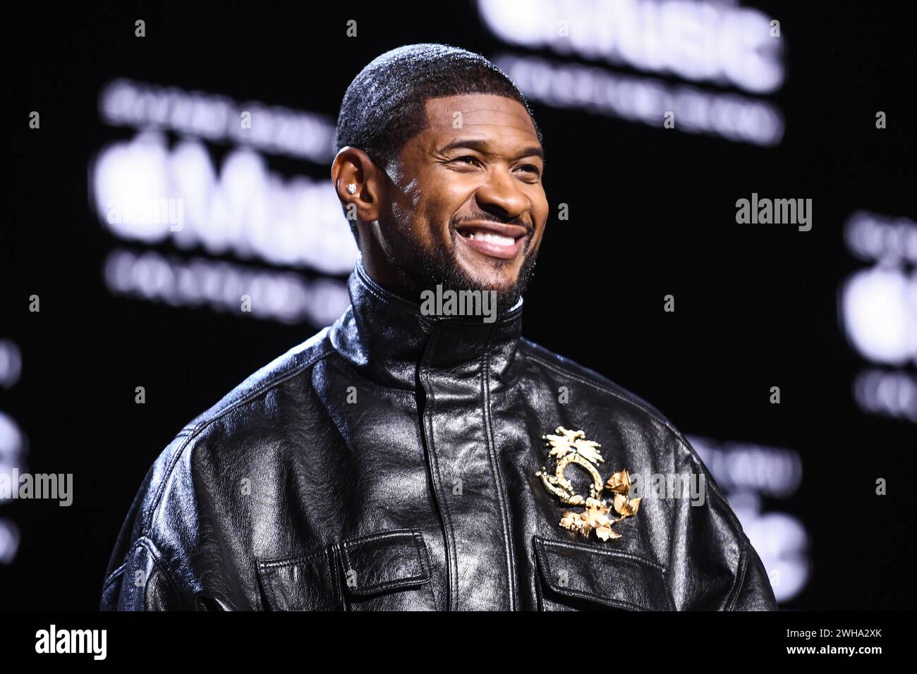 Usher speaks on stage during the Apple Music Super Bowl LVIII Halftime ...