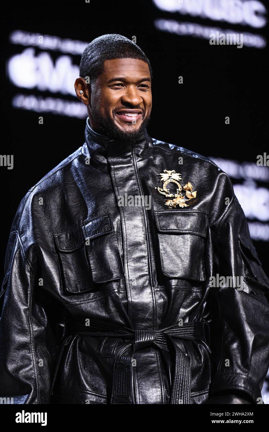 Usher speaks on stage during the Apple Music Super Bowl LVIII Halftime ...