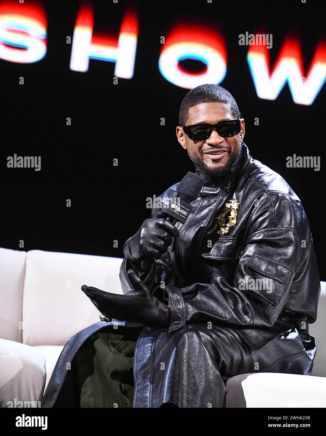 Usher speaks on stage during the Apple Music Super Bowl LVIII Halftime ...