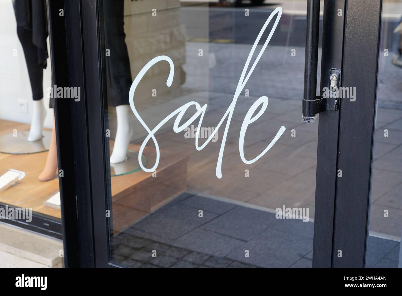 sale signs text in display shop window of clothing store Stock Photo ...