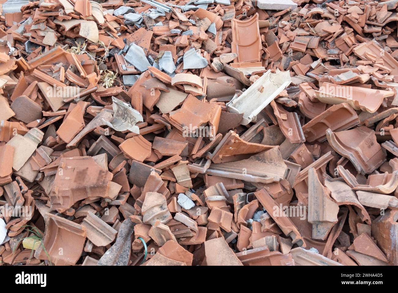 Broken terracotta tiles smashed roof tile Stock Photo - Alamy