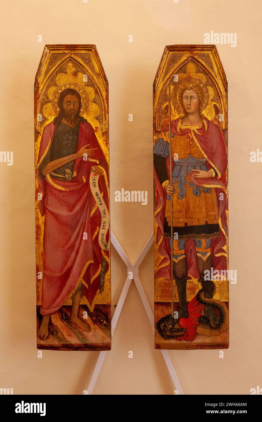 Two ancient icons of Catholic saints stand near the wall Stock Photo ...