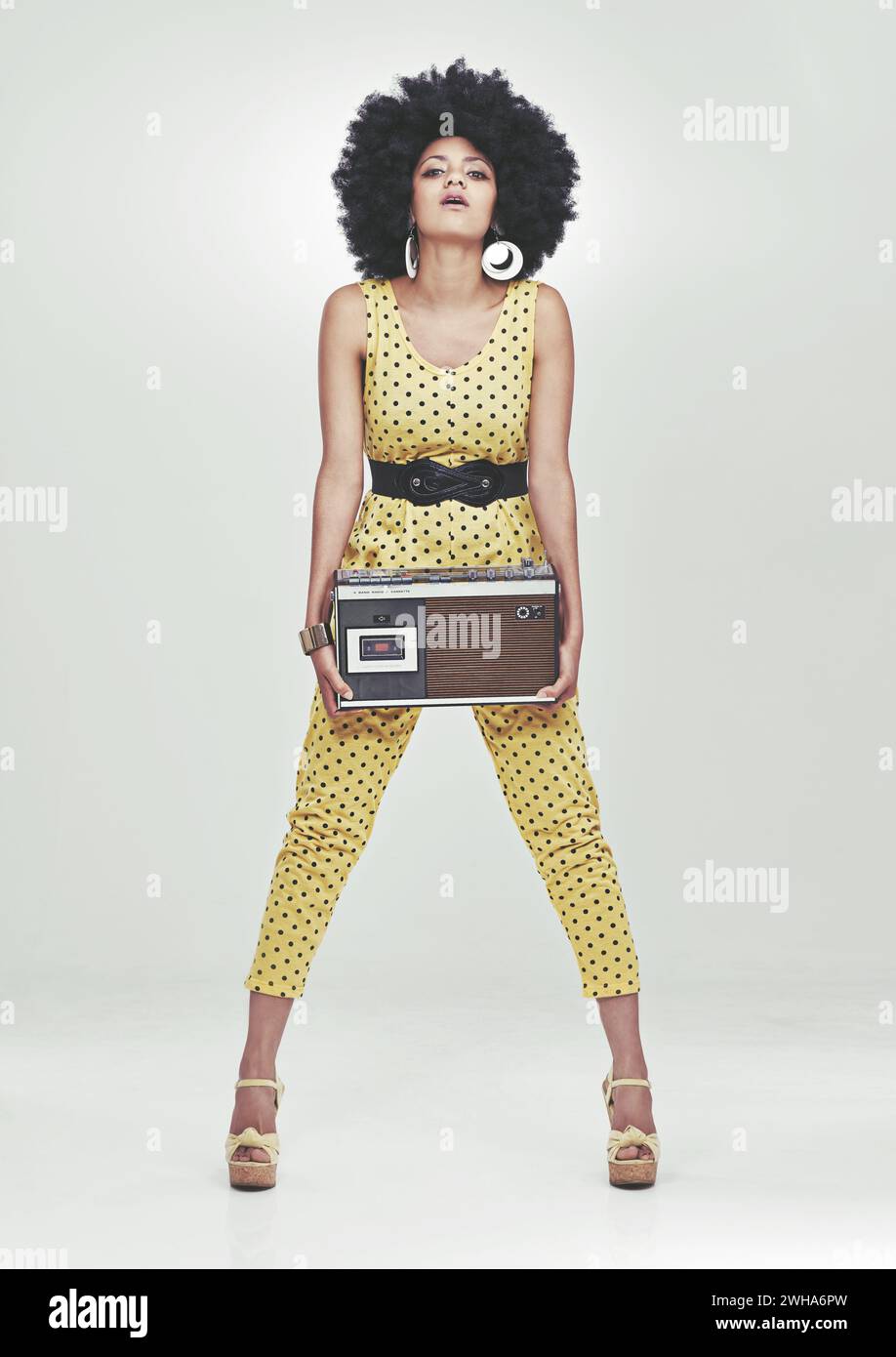 Black woman, fashion in studio with radio in jumpsuit, white background ...