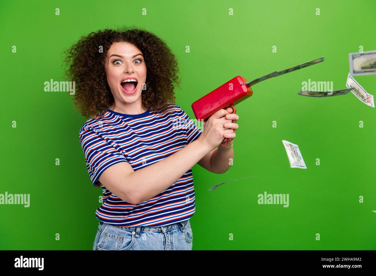 Profile photo of overjoyed cheerful lady hold money gun shoot dollar ...