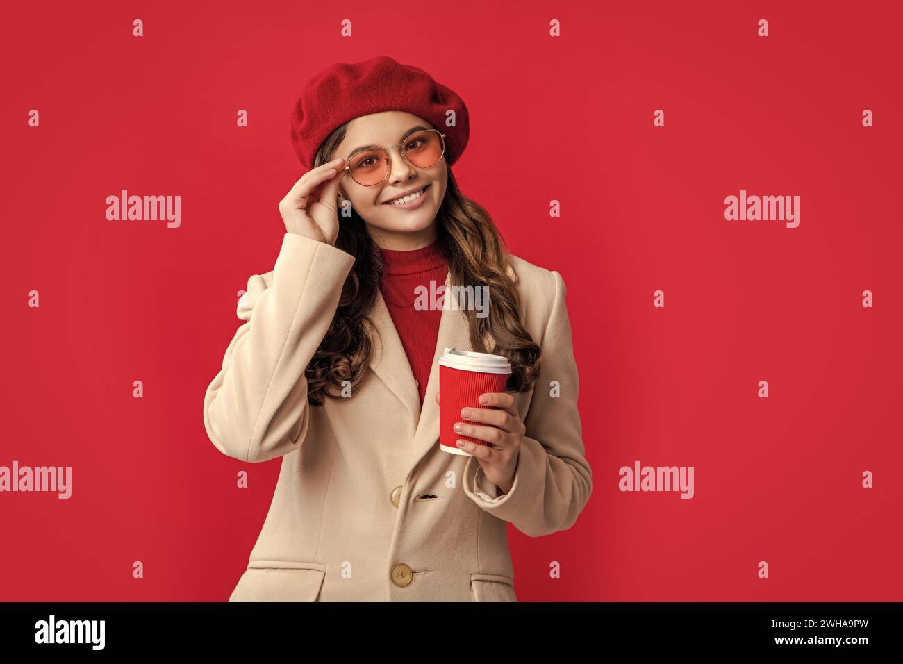 stylish teen girl holding coffee in studio. young stylish teen girl ...