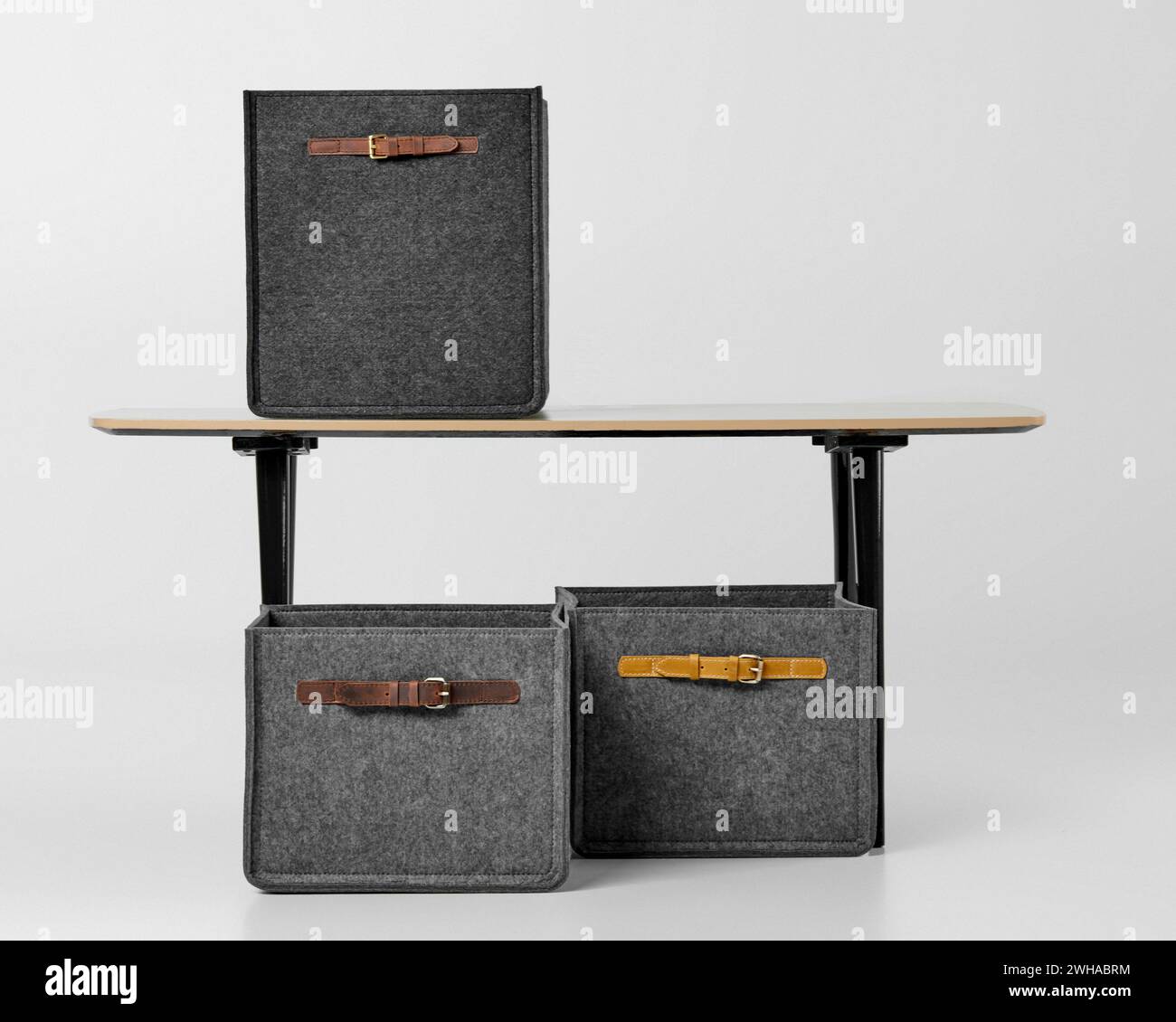 Handcrafted grey felt boxes with leather handles arranged by office ...