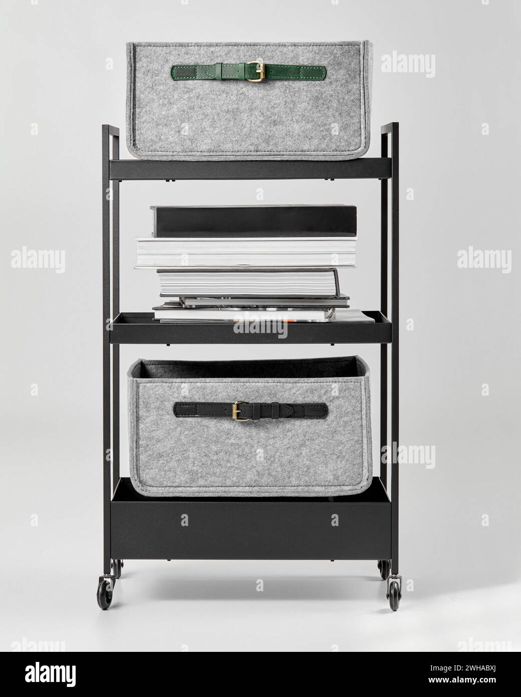 Office trolley with gray felt storage drawers and books on shelves ...