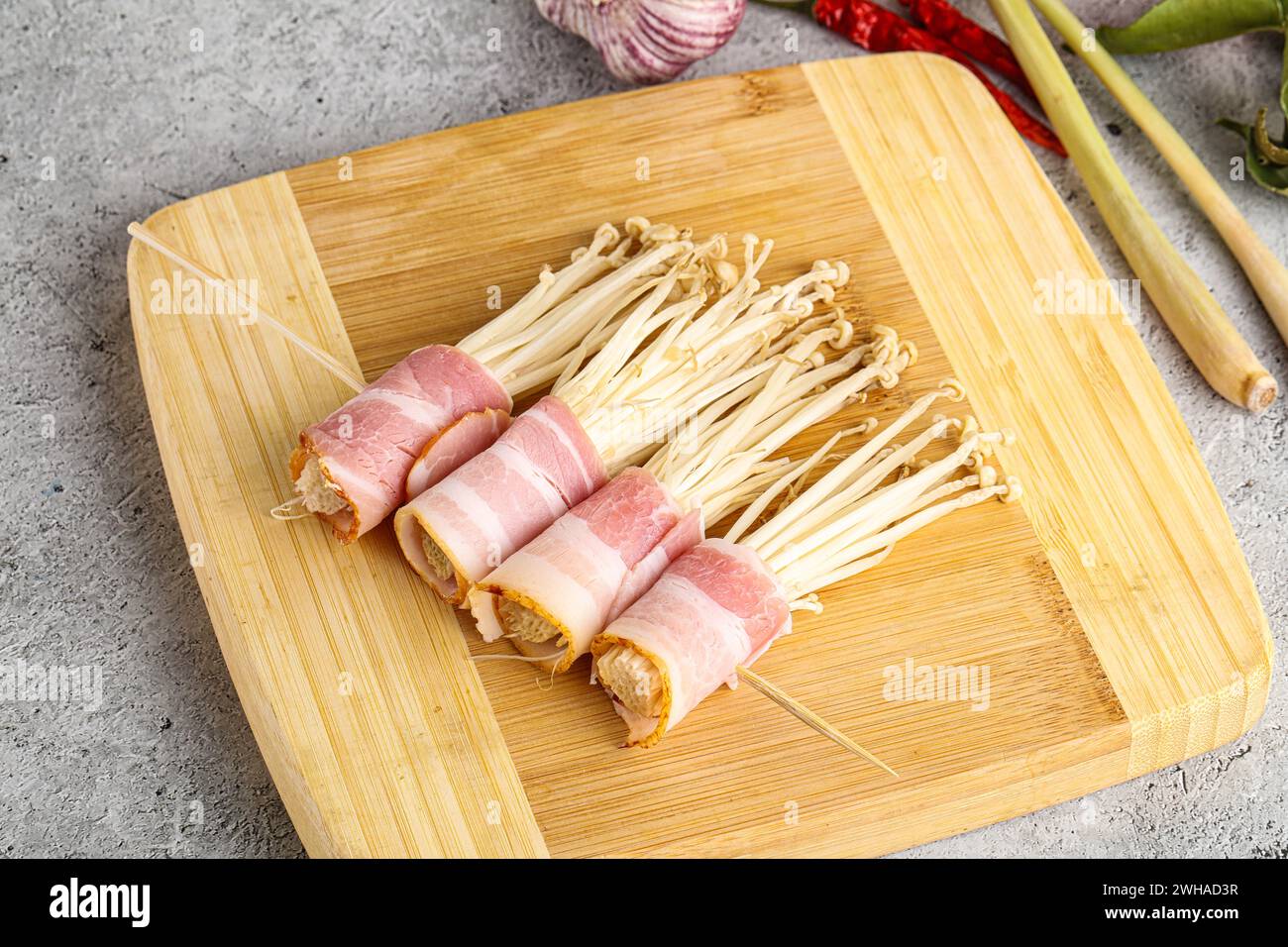 Tasty Raw Enoki mushroom with bacon Stock Photo - Alamy