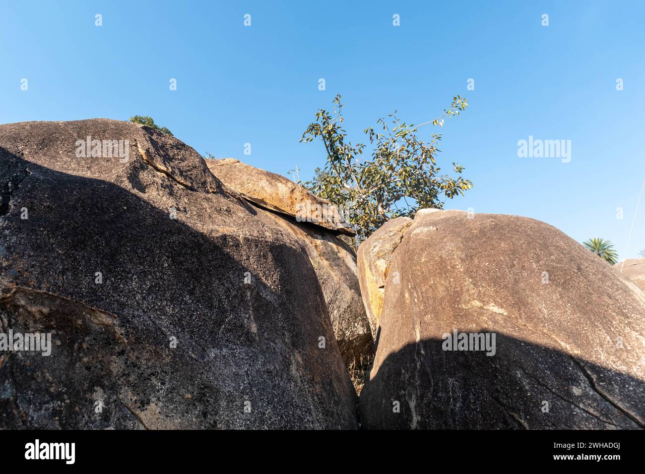 This is a view of giant rocks under the bright blue sky at ...
