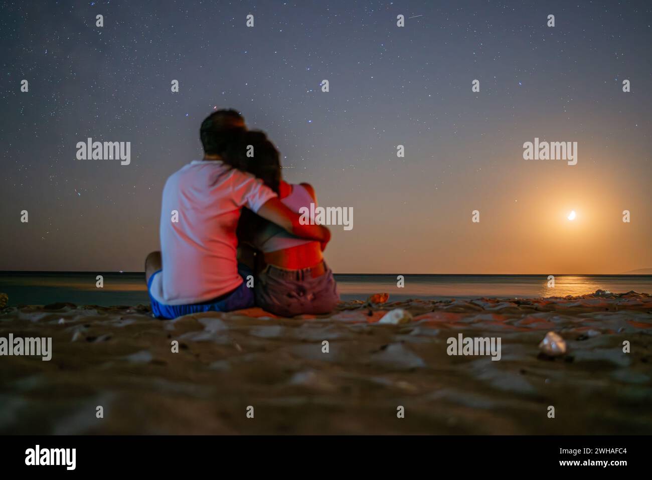 Couple under full moon on the beach hi-res stock photography and images ...