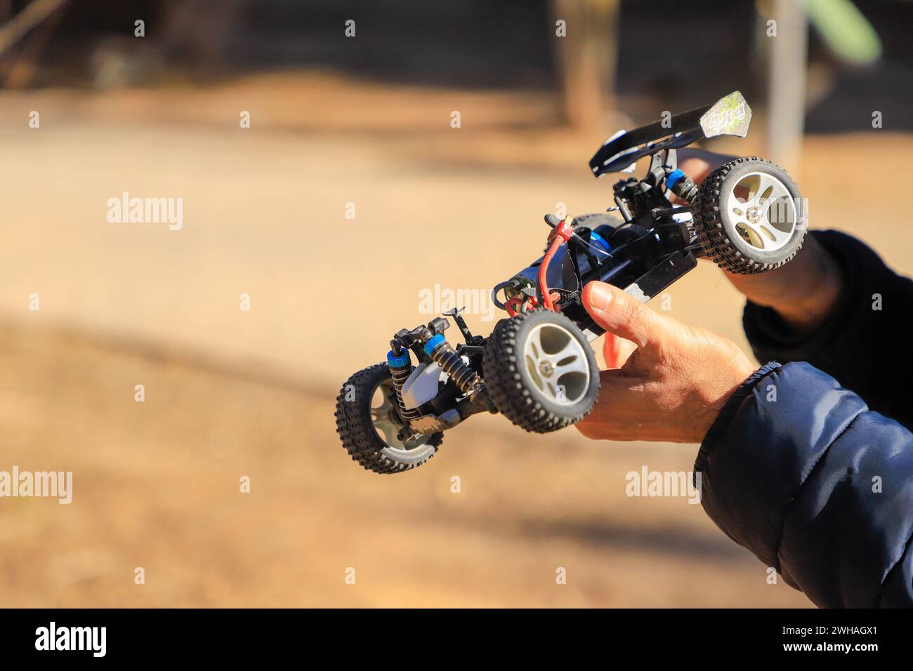 A child playing with a remote-controlled gas-powered toy car Stock ...