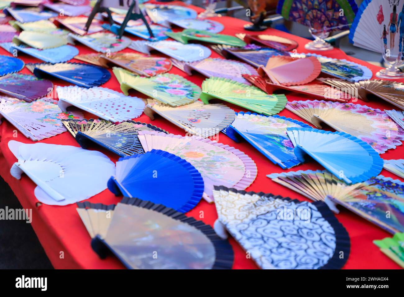A table with colorful hand fans Stock Photo - Alamy