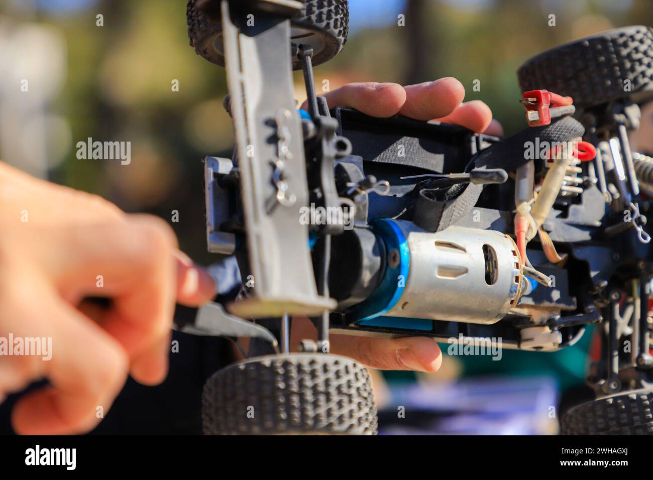 A child playing with a remote-controlled gas-powered toy car Stock ...