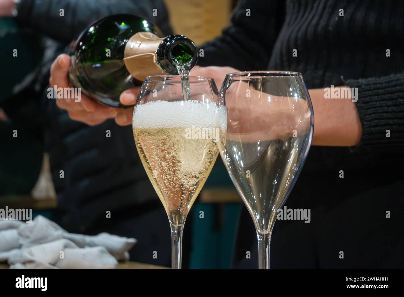 Pouring and tasting of sparkling wine champagne on winter weekend ...