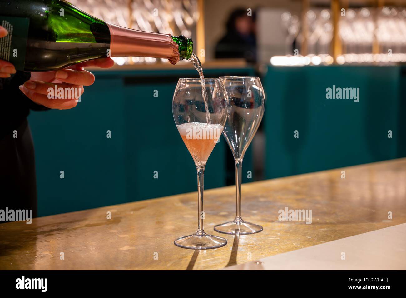 Pouring and tasting of rose sparkling wine champagne on winter weekend ...