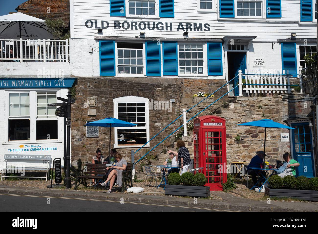 People relaxing at the coffee shops in the streets of Rye historical ...