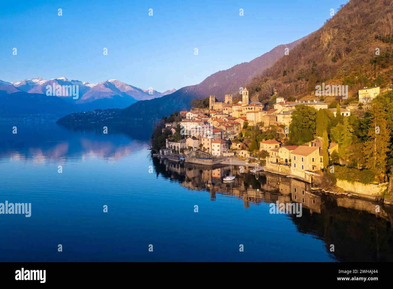 Aerial view at sunset in winter of the medieval village of Corenno ...