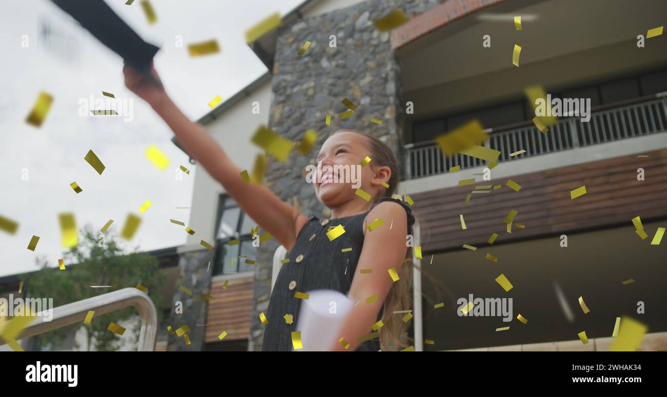 Image of gold confetti over celebrating caucasian schoolgirl throwing ...