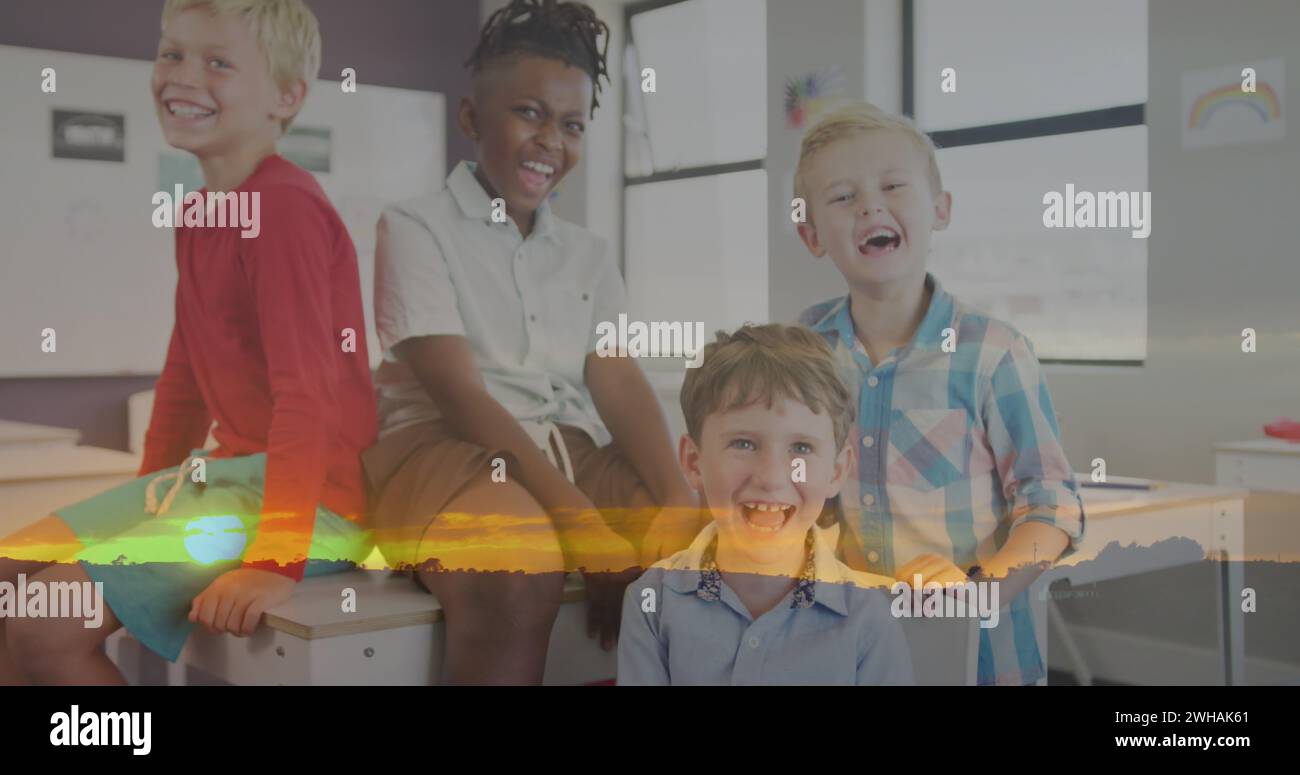 Image of sunset landscape over laughing diverse schoolboys in classroom ...