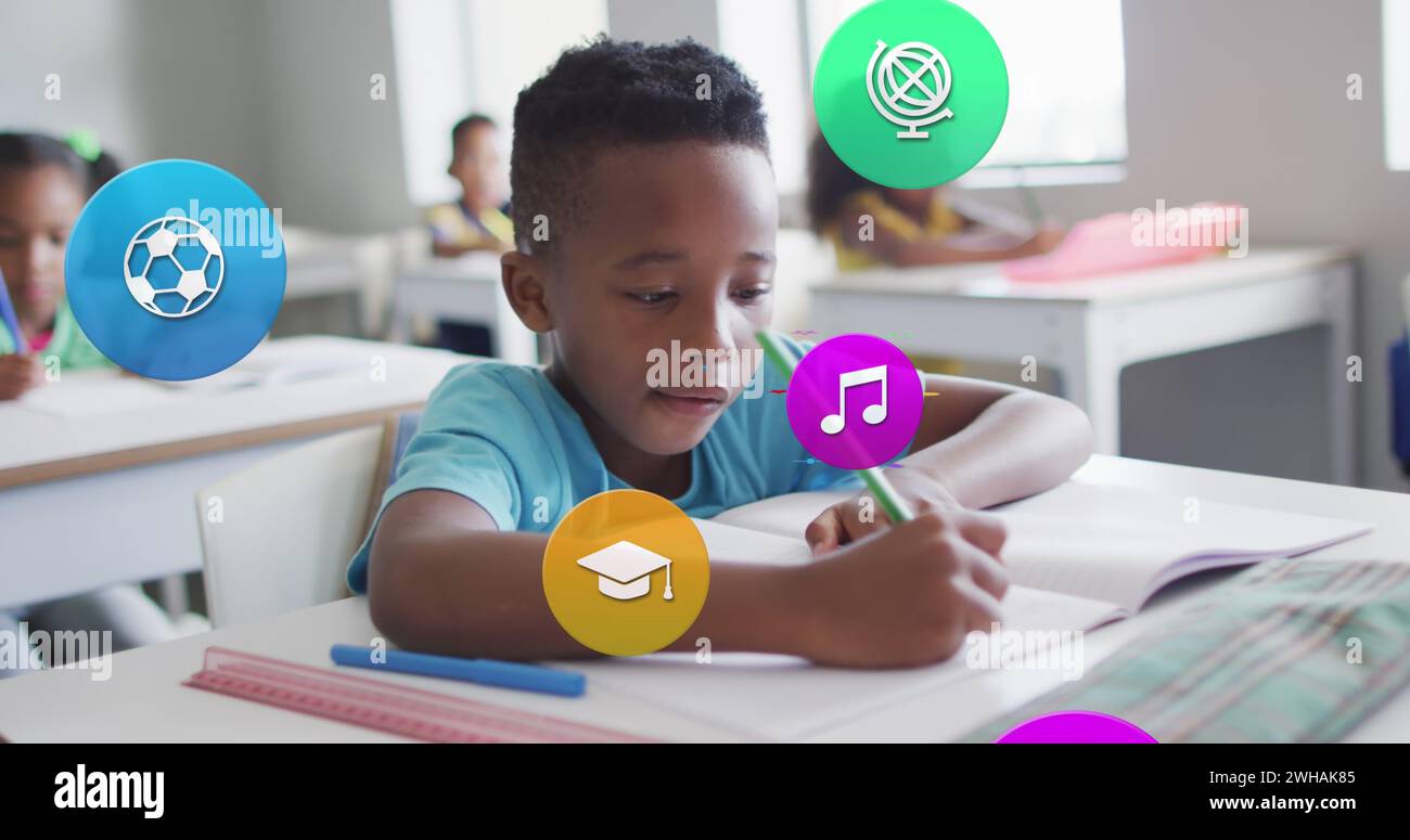 Image of school icons over busy african american schoolboy working at ...