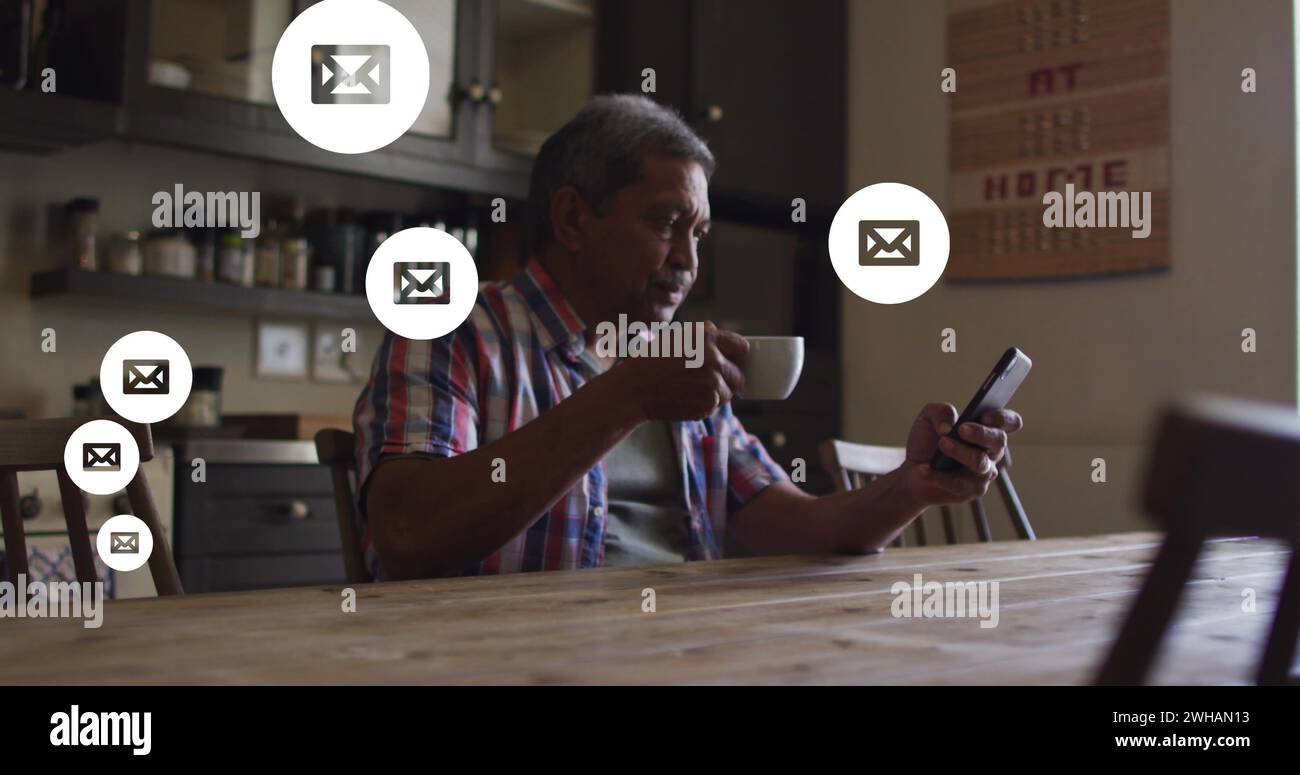 Multiple message icons floating against senior using smartphone at home ...