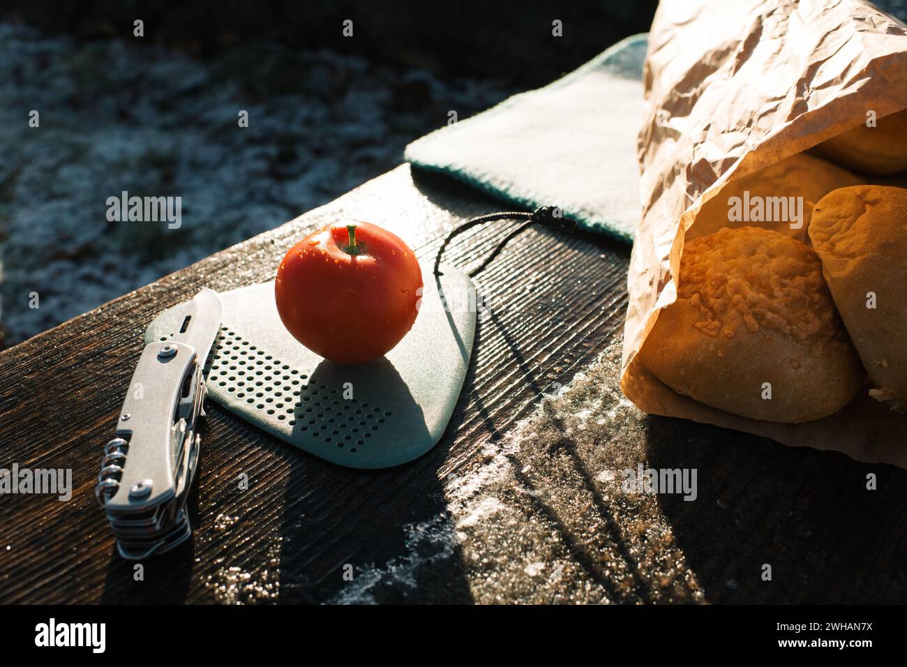 tomato on a chopping board with a pen knife on a log outdoors Stock ...