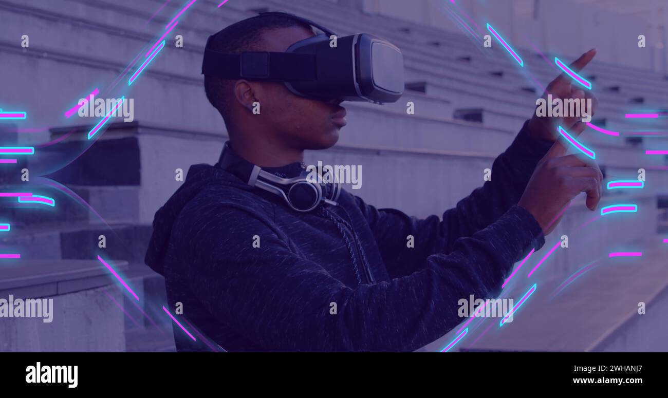 Image of glowing light trails of data transfer over african american ...