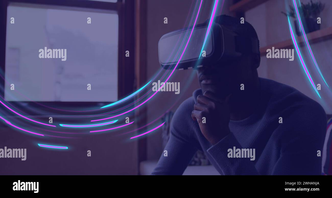 Image of glowing light trails of data transfer over african american ...