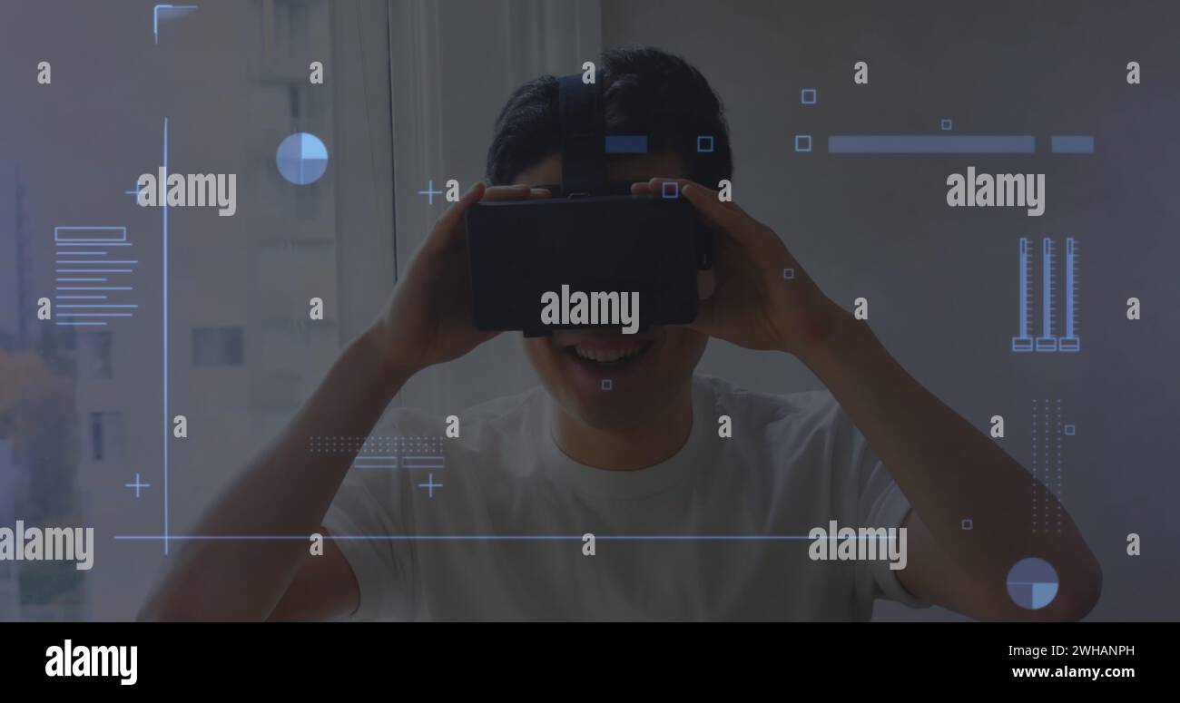 Digital interface with data processing against asian man wearing vr headset at home Stock Photo ...