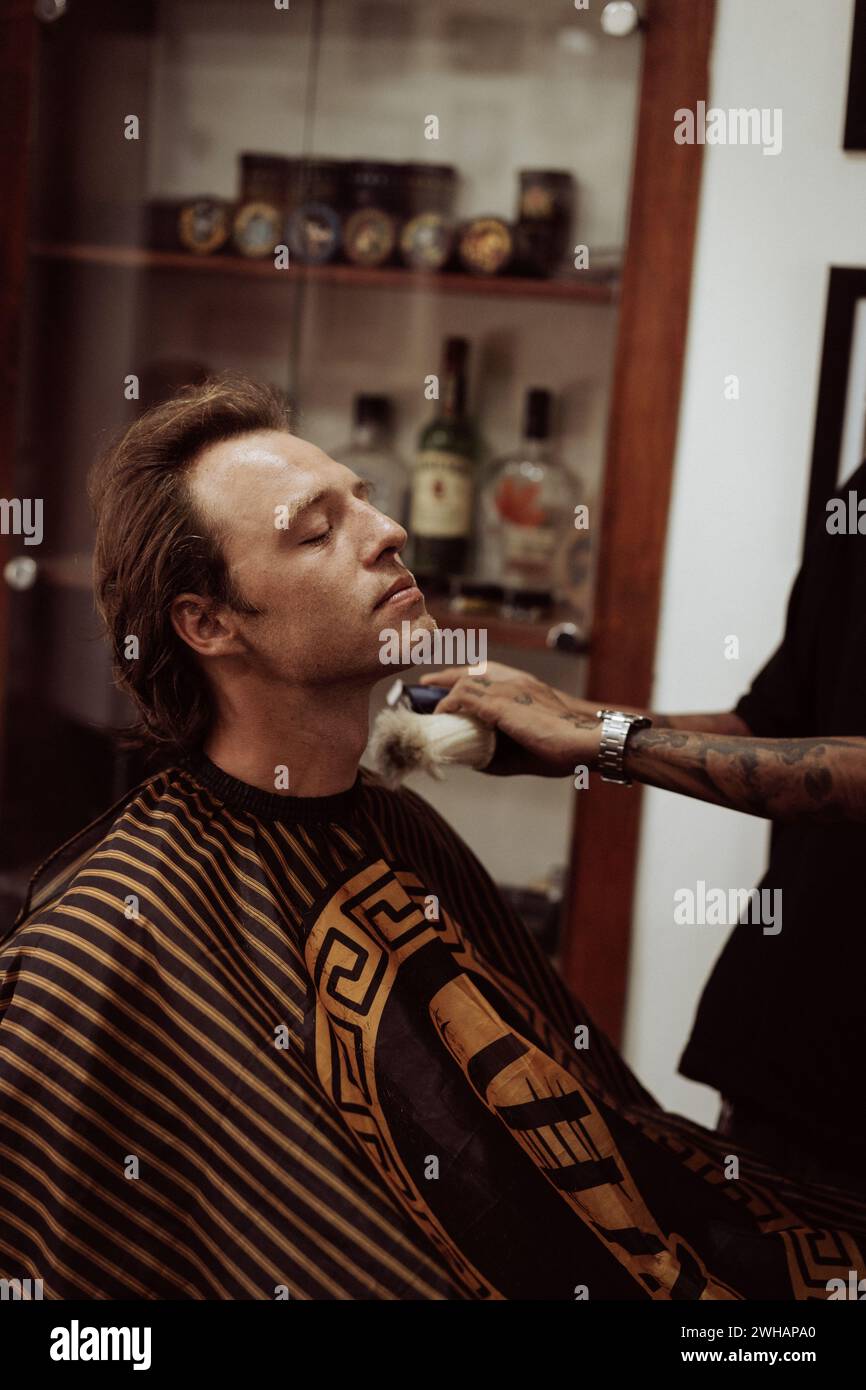 Man in barbershop shaving beard. Beard care Stock Photo - Alamy