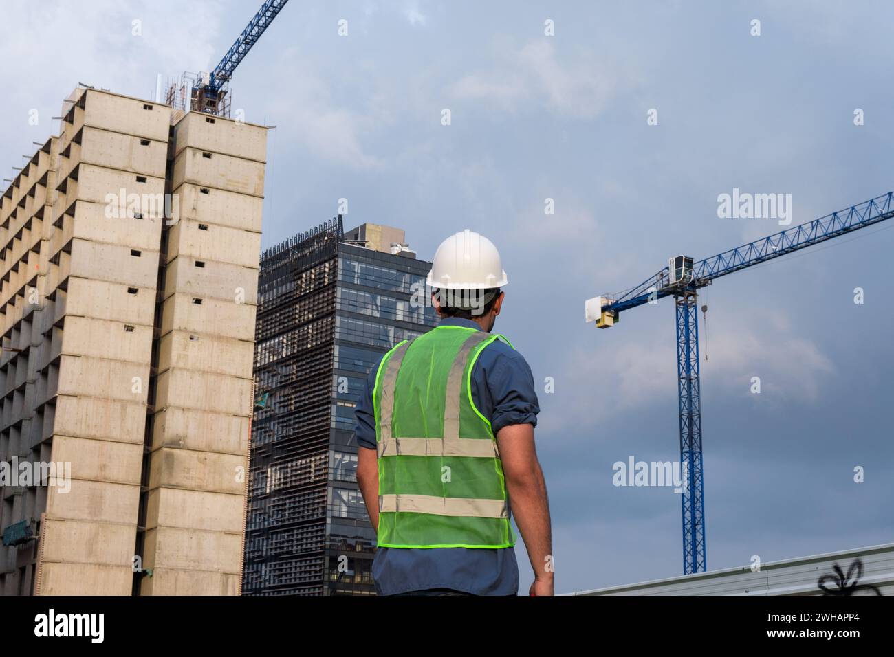 Engineer man working and looking construction site Stock Photo - Alamy