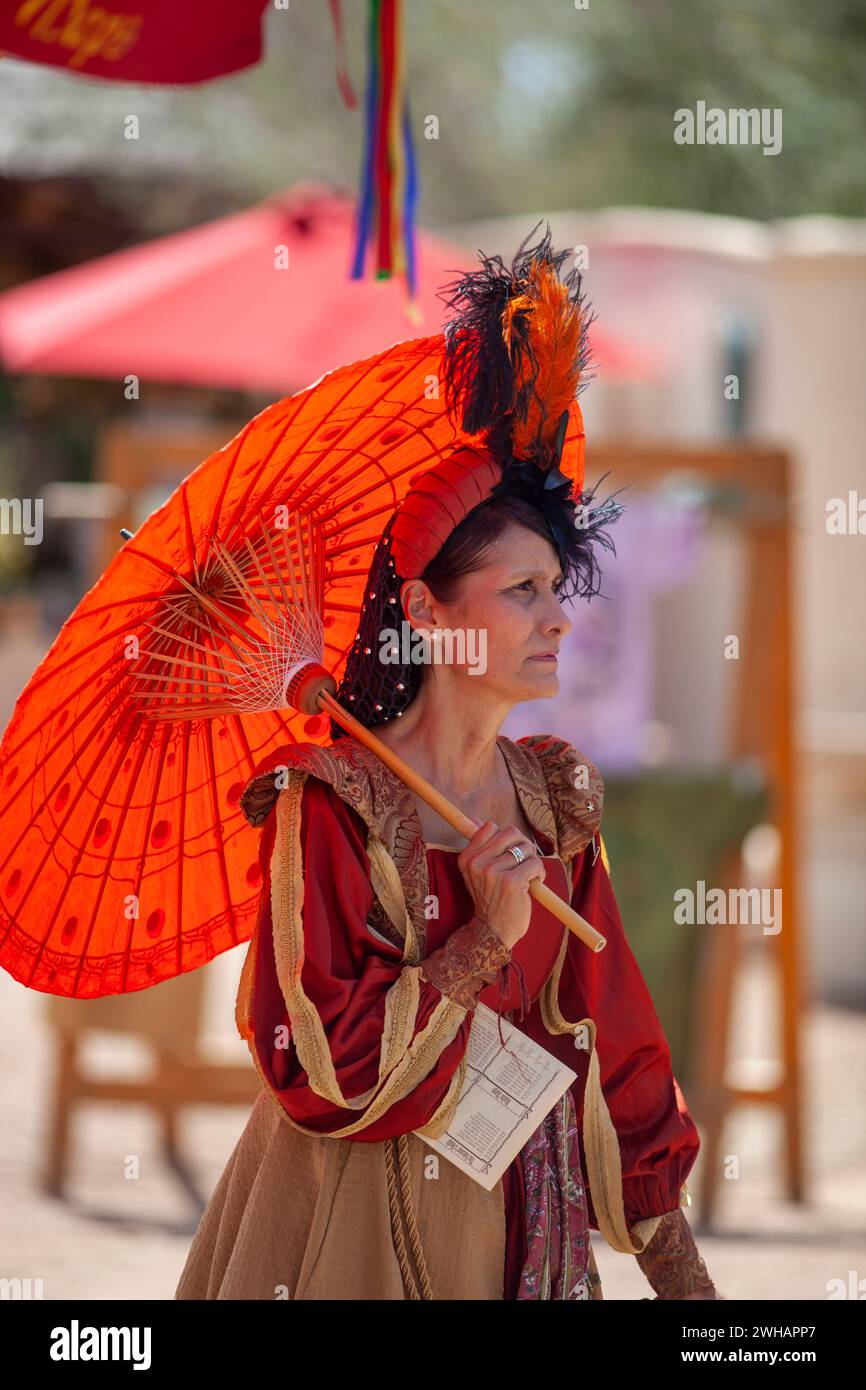 Woman wearing renaissance costume carrying umbrella vertical Stock ...
